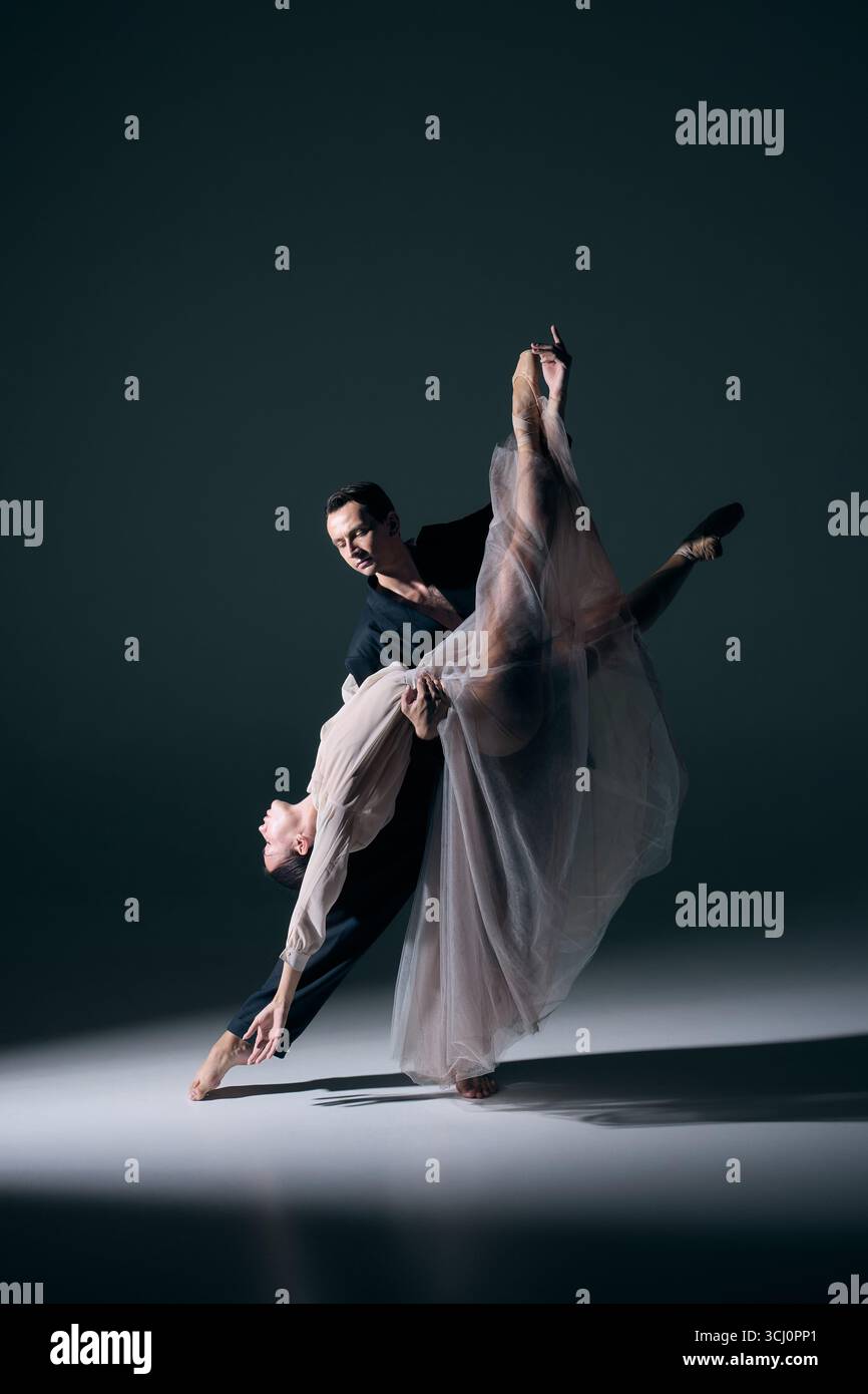 Ballet partners in bold lift with flowing fabric and sculptural ...