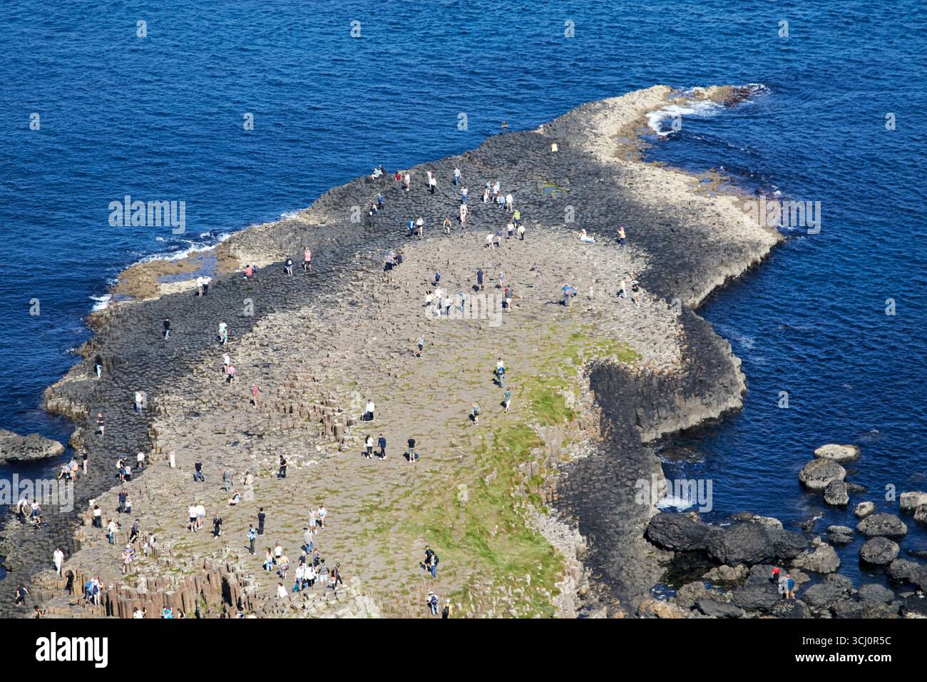 looking down from viewpoint on the upper cliff path at tourists on the ...