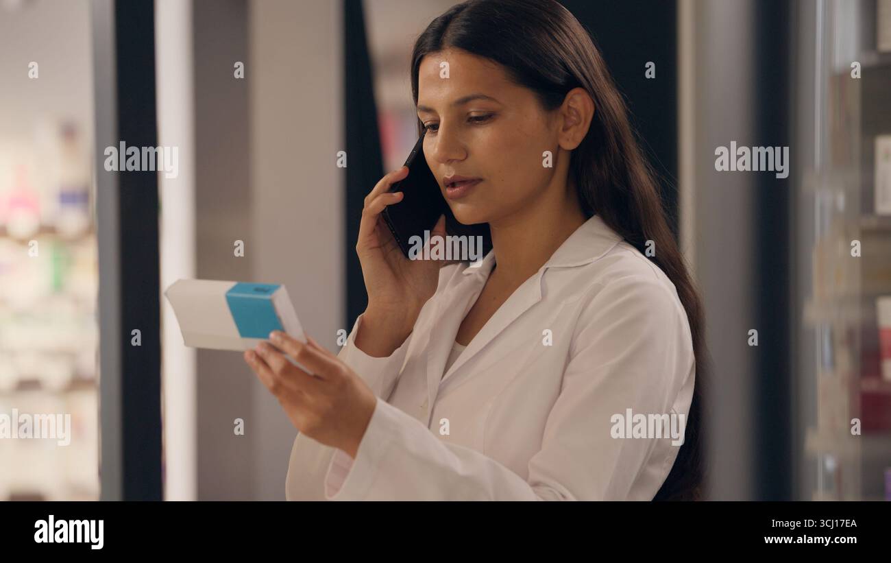 Indian woman pharmacist talking mobile hi-res stock photography and ...
