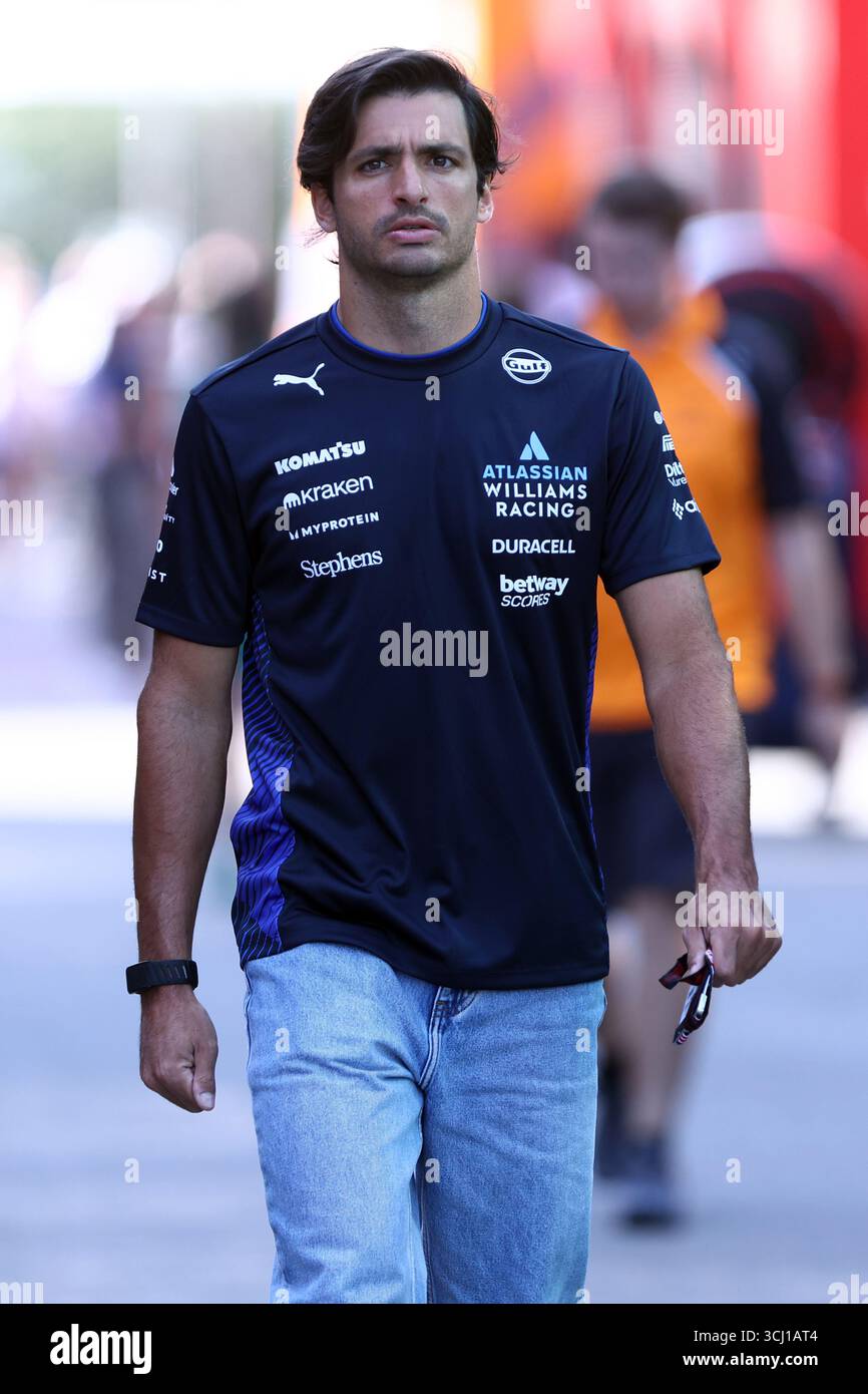 Carlos Sainz of Williams Racing looks on in the Paddock during previews ...