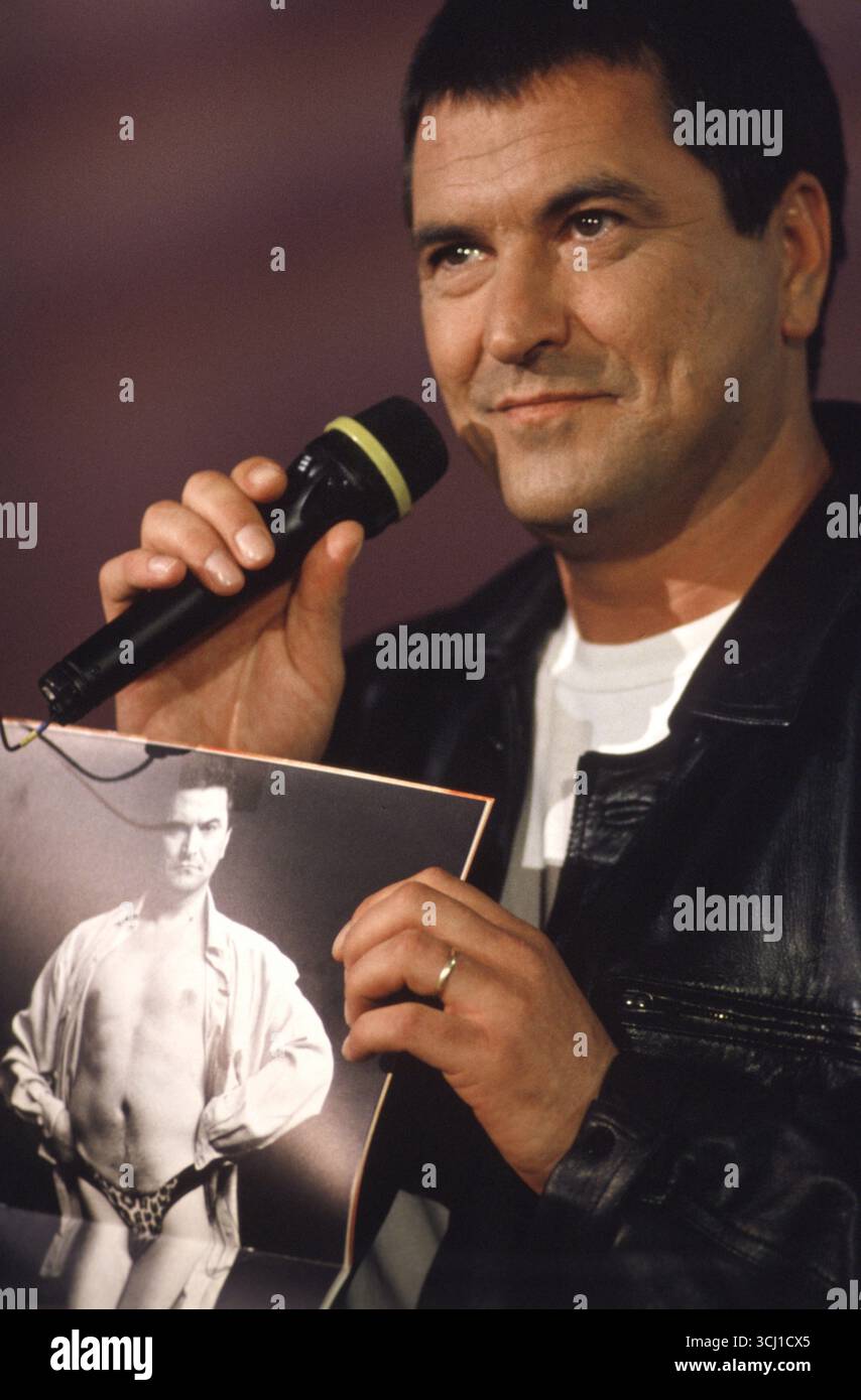 French comedian Jean-Marie Bigard holding up the poster for his show ...