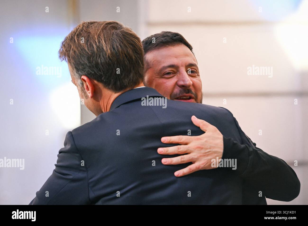 French President Emmanuel Macron hugs Ukrainian President Volodymyr ...
