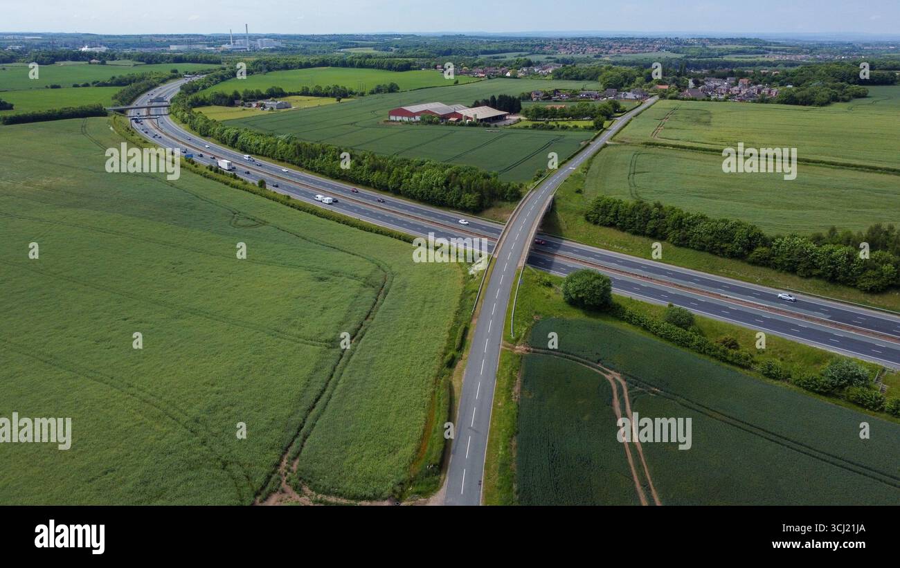 Drone view of farmland and countryside with motorway traffic, an ...