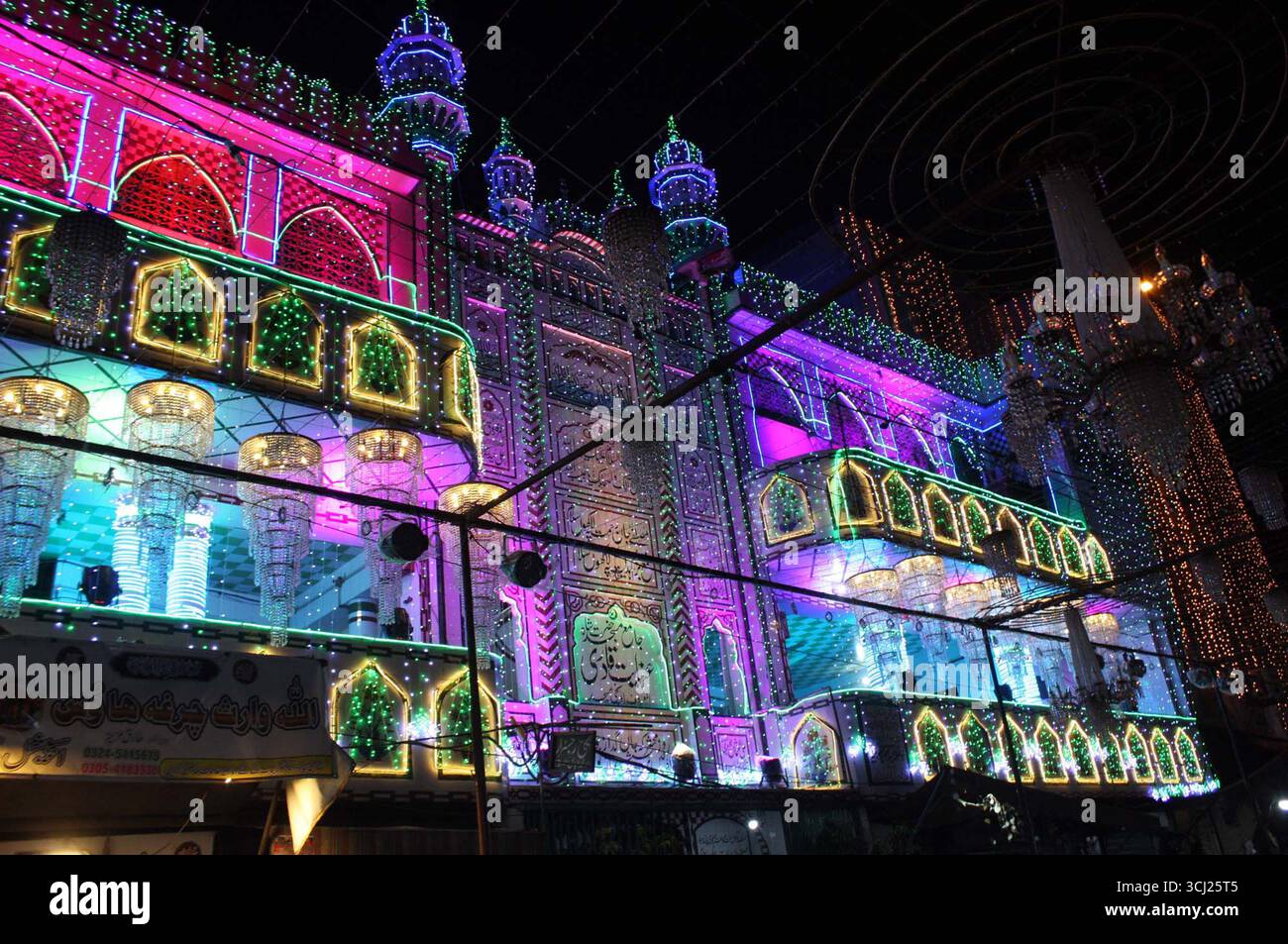A beautiful illuminated view of the Oonchi Mosque decorated with lights ...