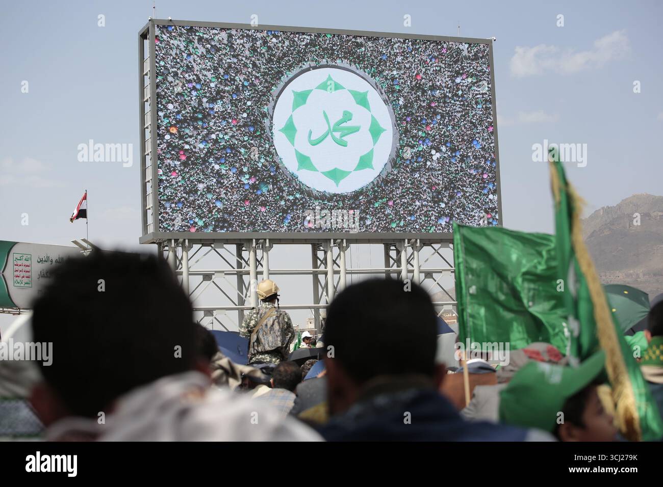 People wave Islamic flags during the Mawlid celebration marking the ...