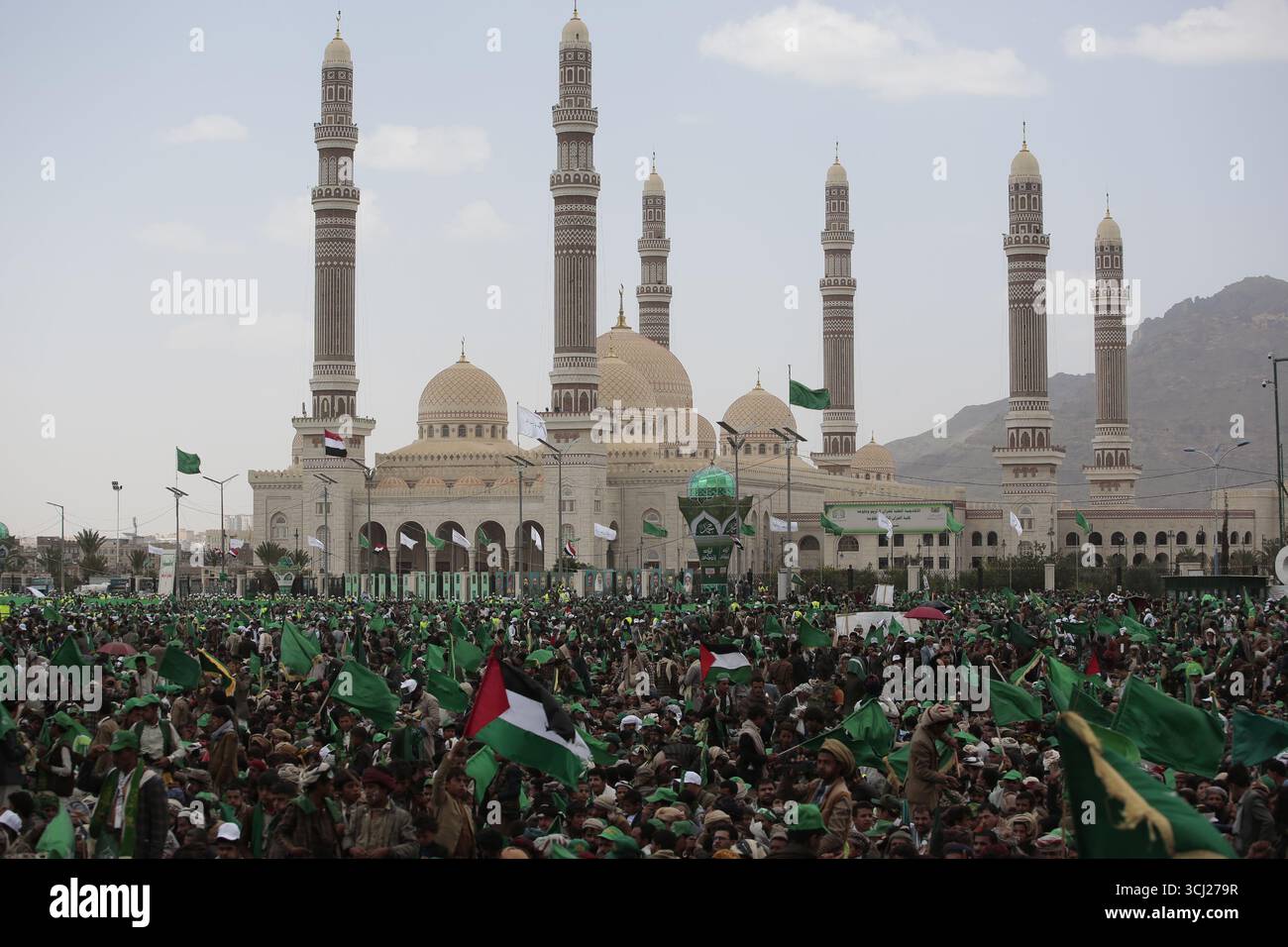 People wave Islamic flags during the Mawlid celebration marking the ...