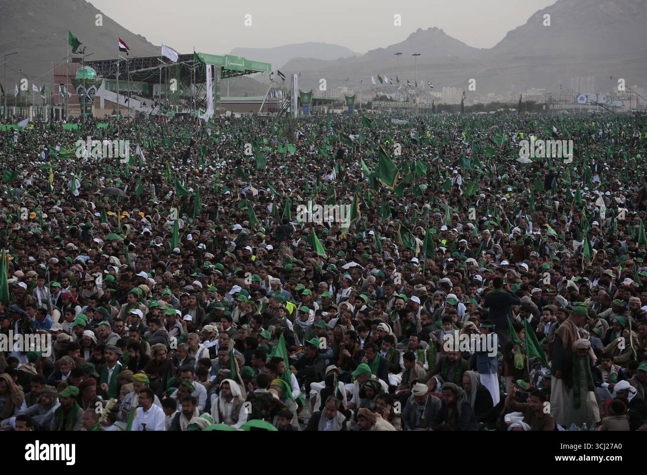 People wave Islamic flags during the Mawlid celebration marking the ...