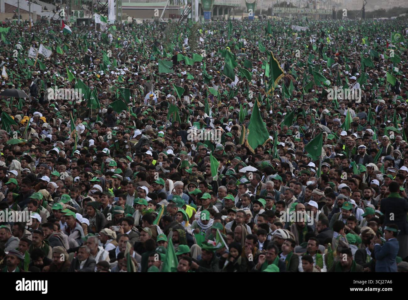 People wave Islamic flags during the Mawlid celebration marking the ...