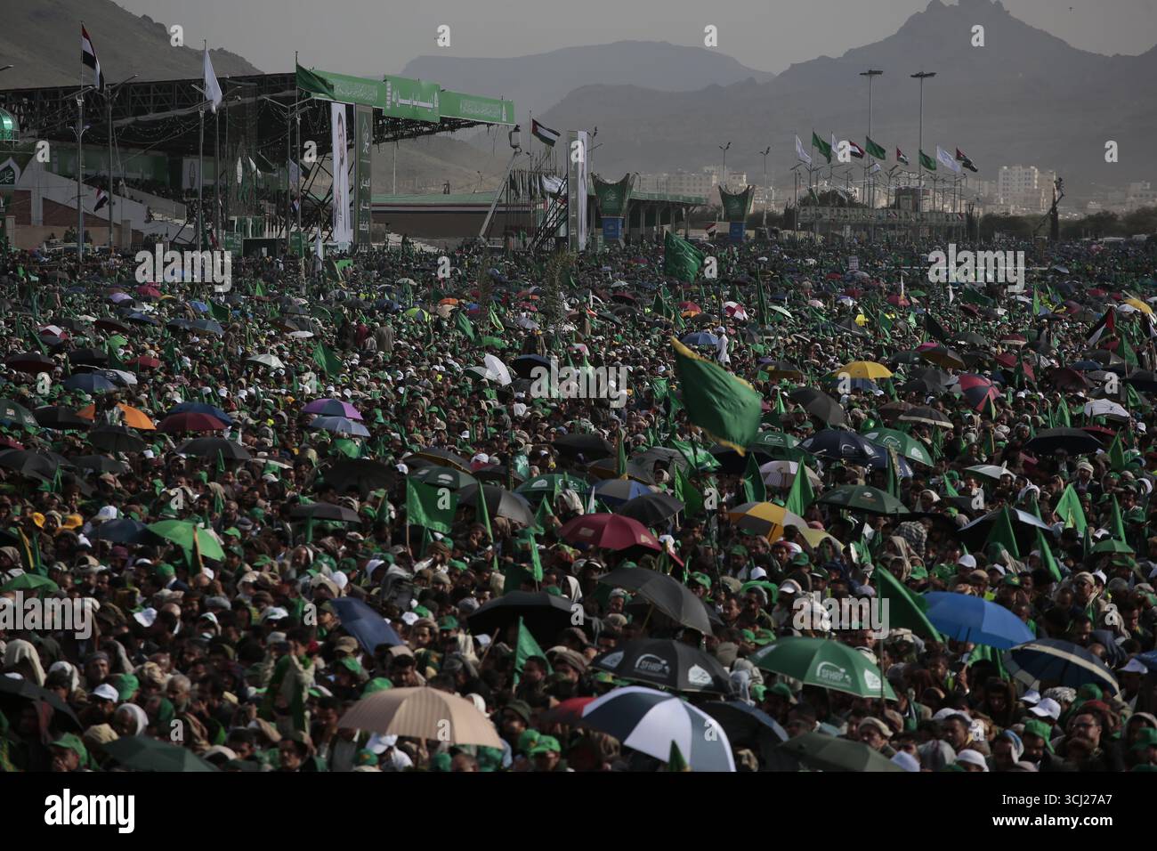 People wave Islamic flags during the Mawlid celebration marking the ...