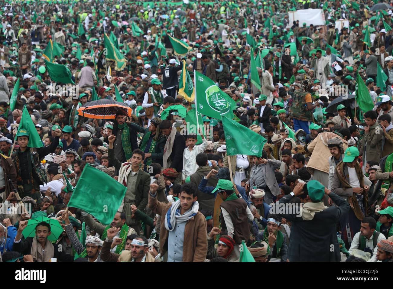 People wave Islamic flags during the Mawlid celebration marking the ...