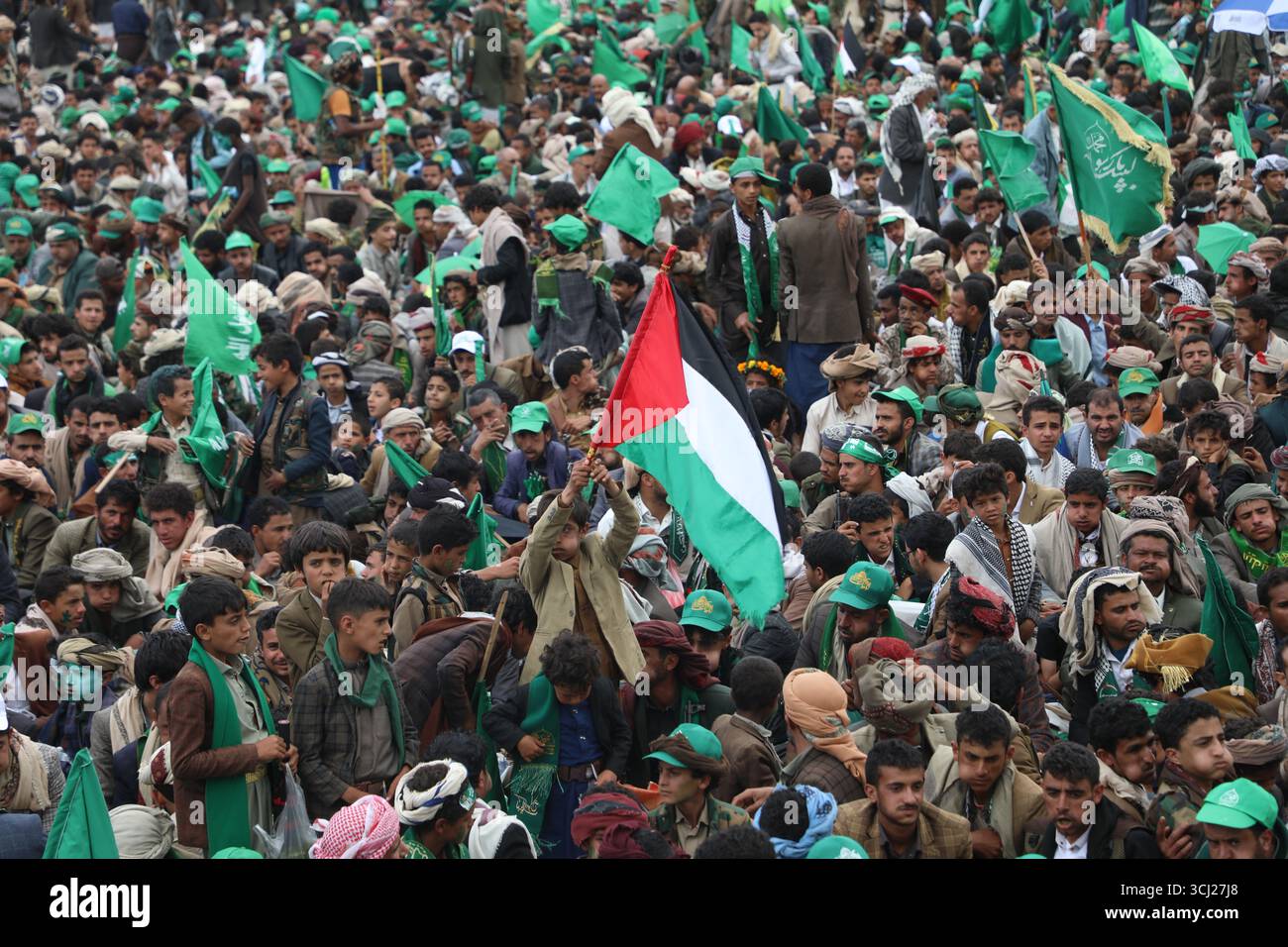 People wave Islamic flags during the Mawlid celebration marking the ...