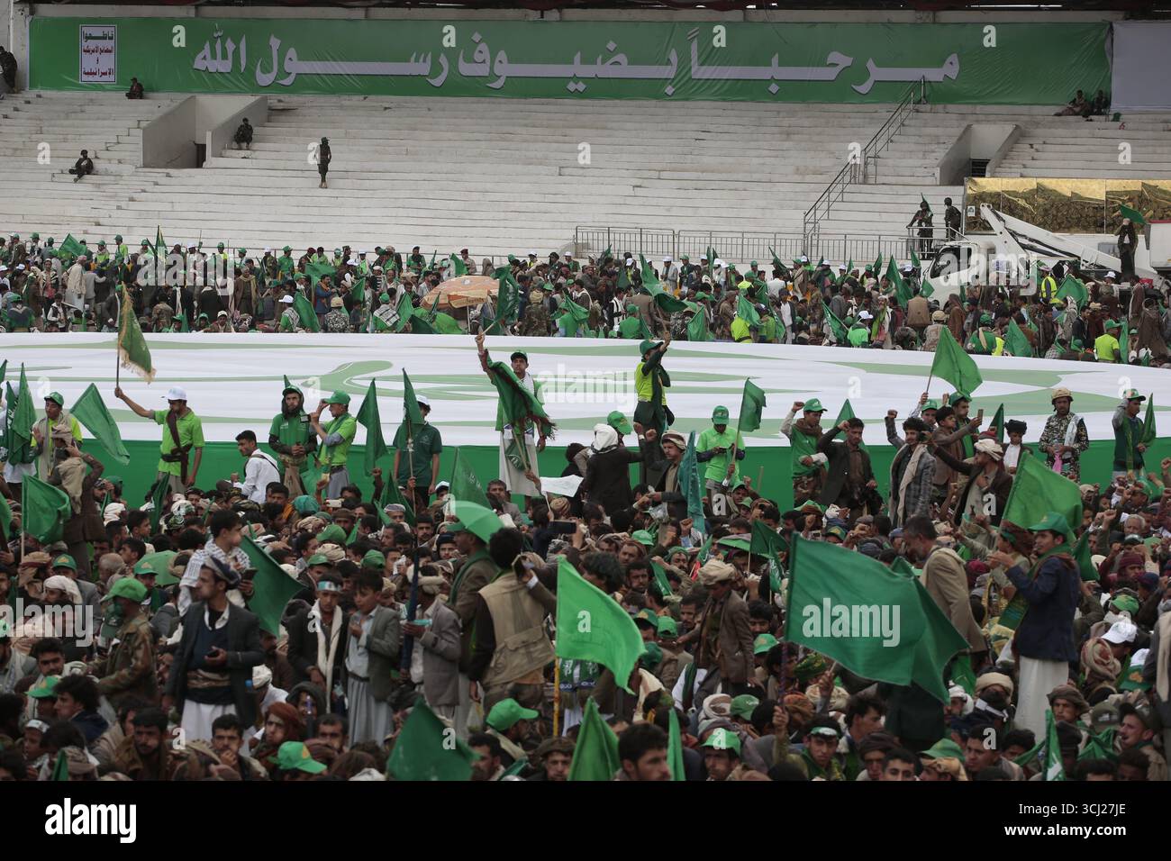 People wave Islamic flags during the Mawlid celebration marking the ...