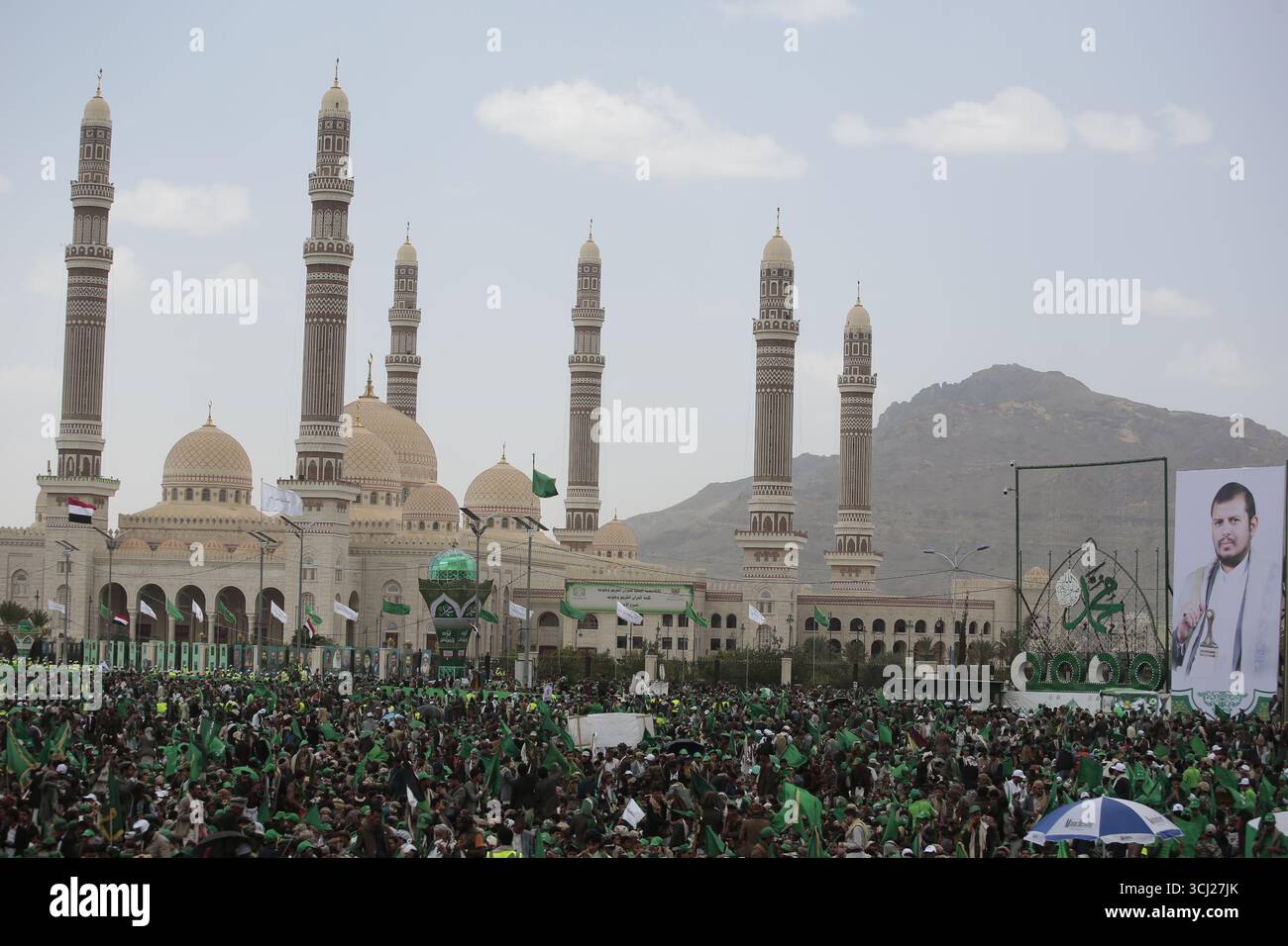 People wave Islamic flags during the Mawlid celebration marking the ...
