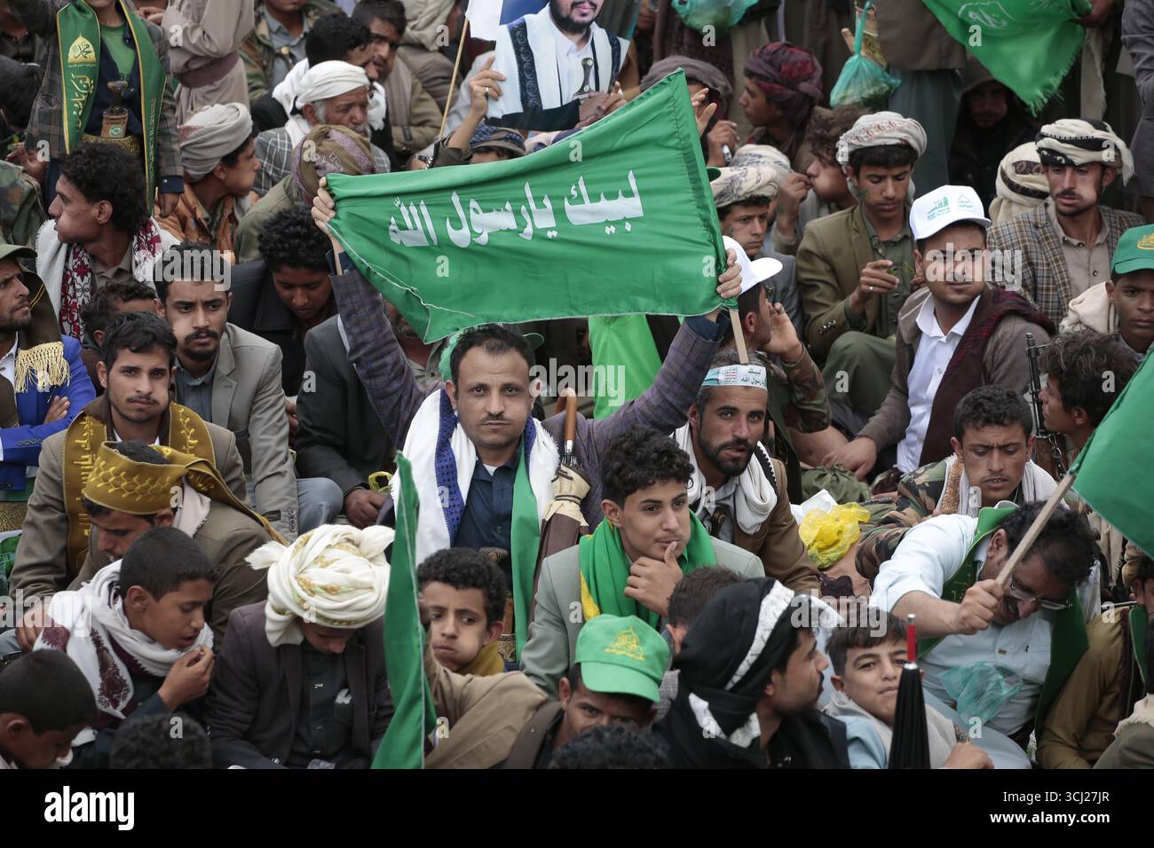 People wave Islamic flags during the Mawlid celebration marking the ...