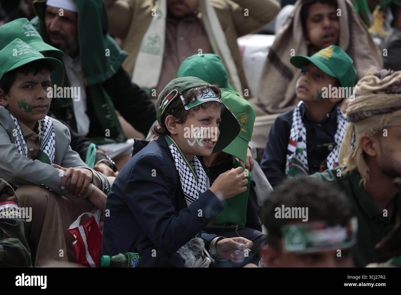 People wave Islamic flags during the Mawlid celebration marking the ...