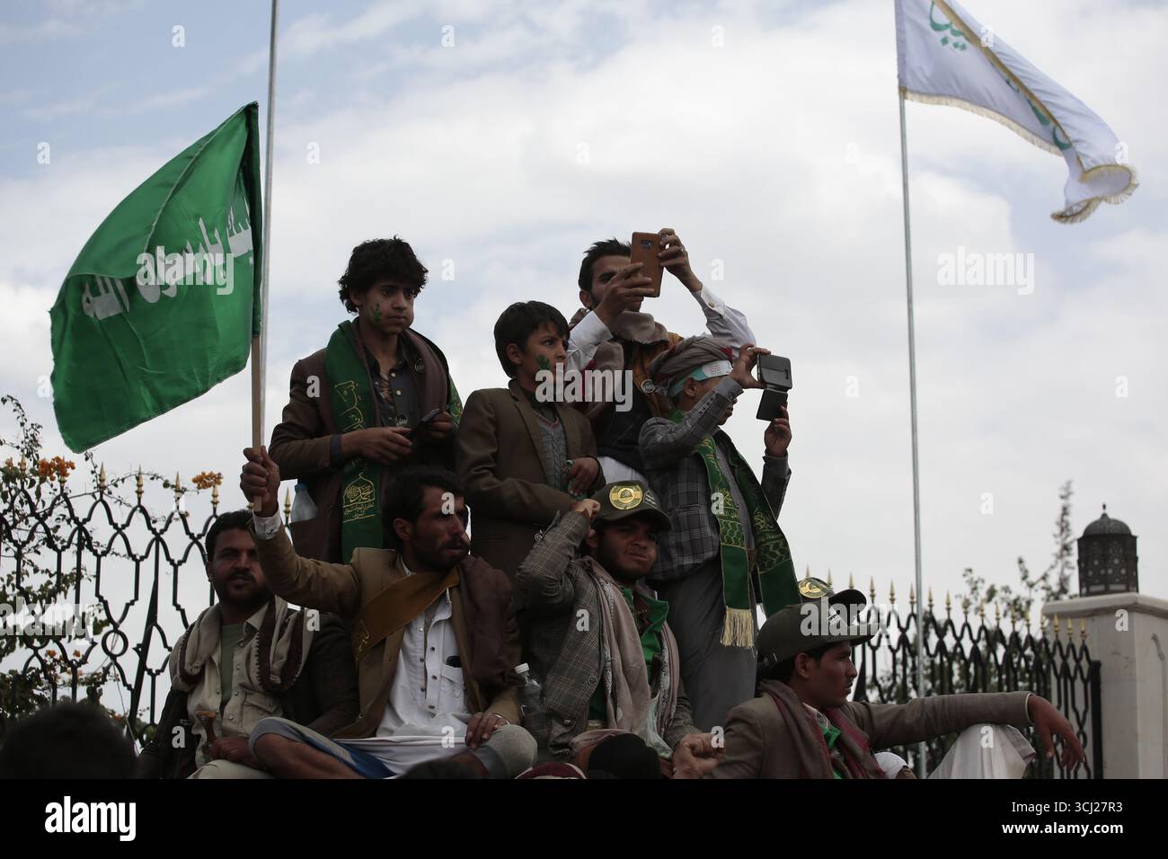 People wave Islamic flags during the Mawlid celebration marking the ...