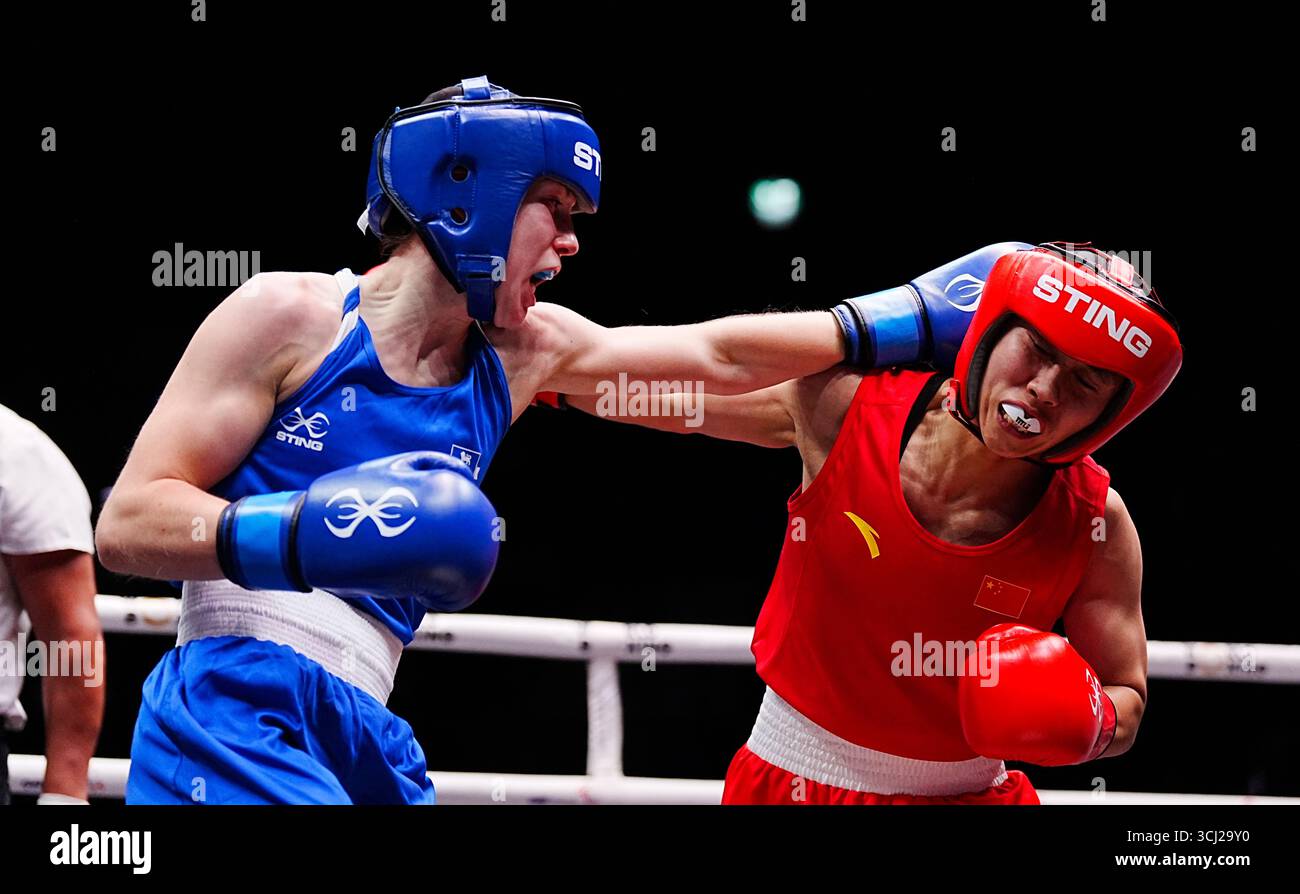 Lauren Mackie (left) in action against Cao Wanqi in their Women's 54kg ...