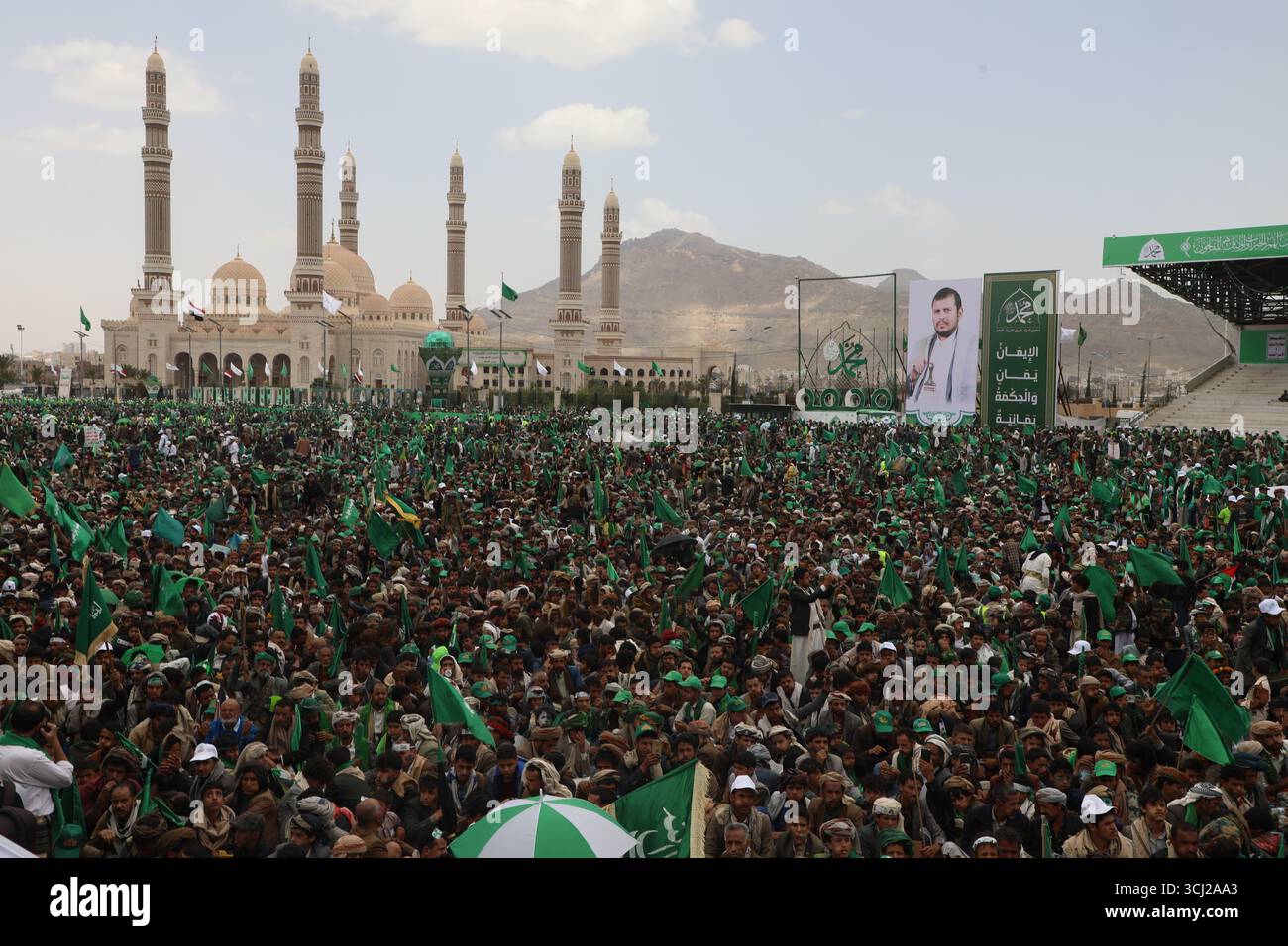 People wave Islamic flags during the Mawlid celebration marking the ...