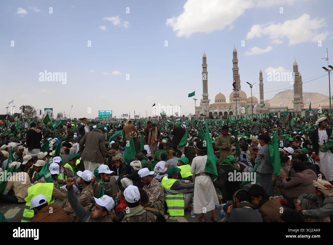 People wave Islamic flags during the Mawlid celebration marking the ...