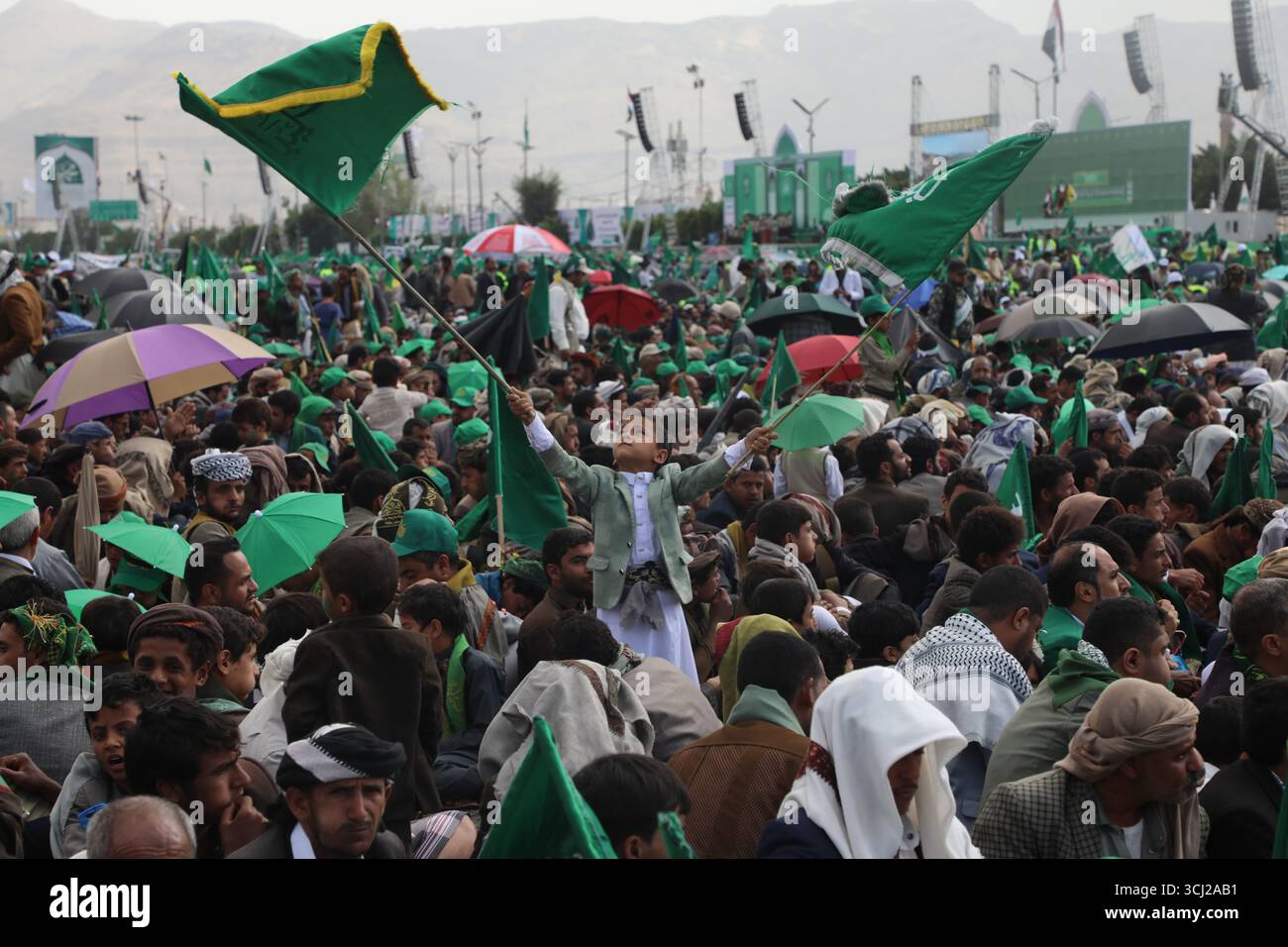 People wave Islamic flags during the Mawlid celebration marking the ...