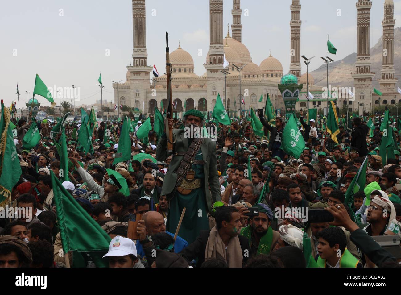 People wave Islamic flags during the Mawlid celebration marking the ...