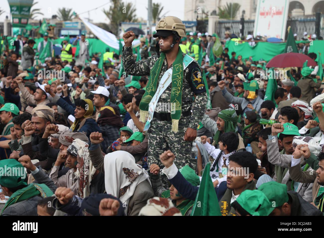 People wave Islamic flags during the Mawlid celebration marking the ...
