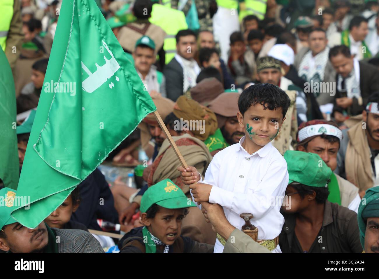 People wave Islamic flags during the Mawlid celebration marking the ...