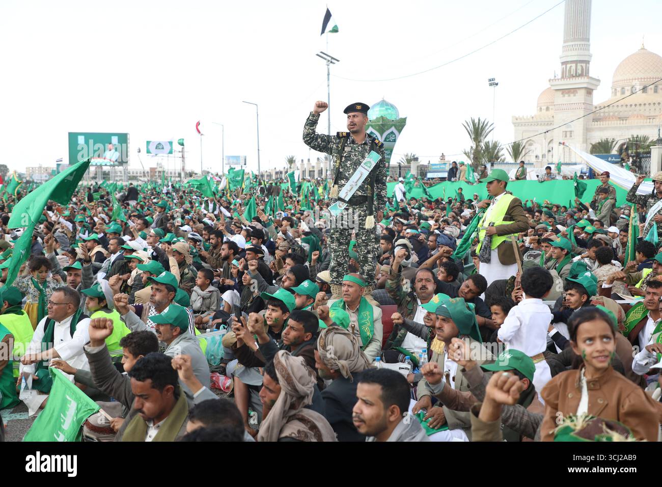 People wave Islamic flags during the Mawlid celebration marking the ...