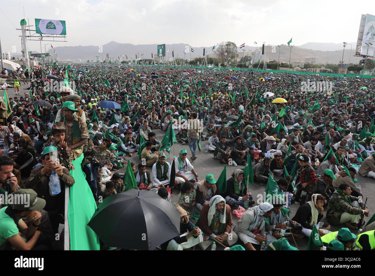 People wave Islamic flags during the Mawlid celebration marking the ...