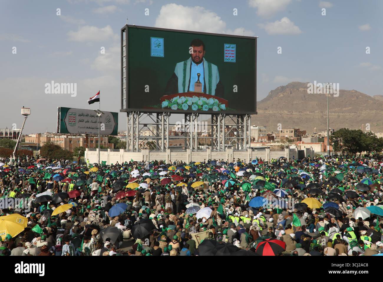 People watch Houthi leader Abdul-Malik Al-Houthi on a large screen ...