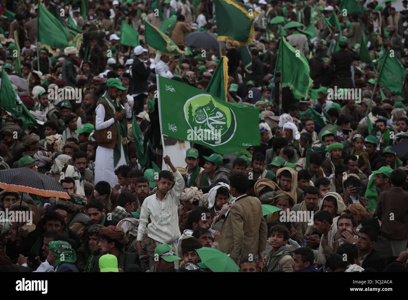 People wave Islamic flags during the Mawlid celebration marking the ...