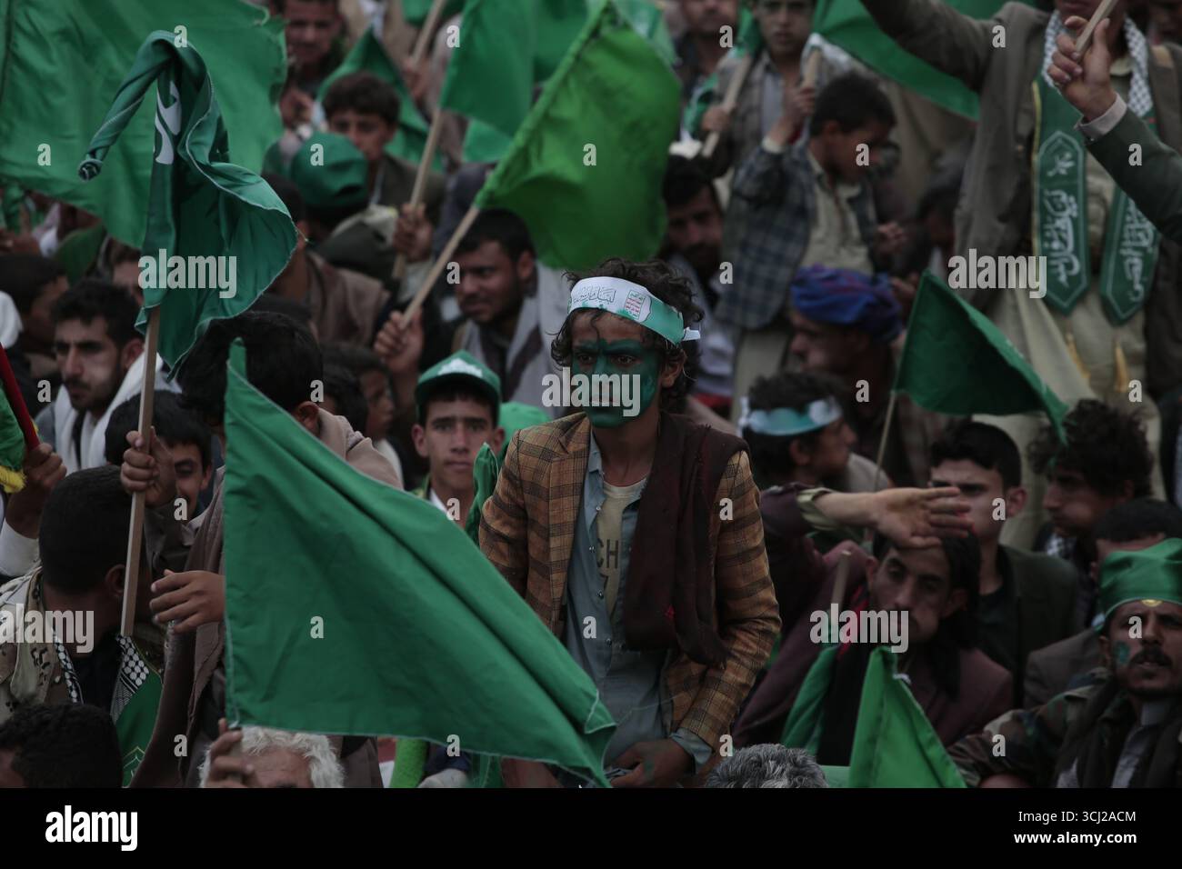 People wave Islamic flags during the Mawlid celebration marking the ...