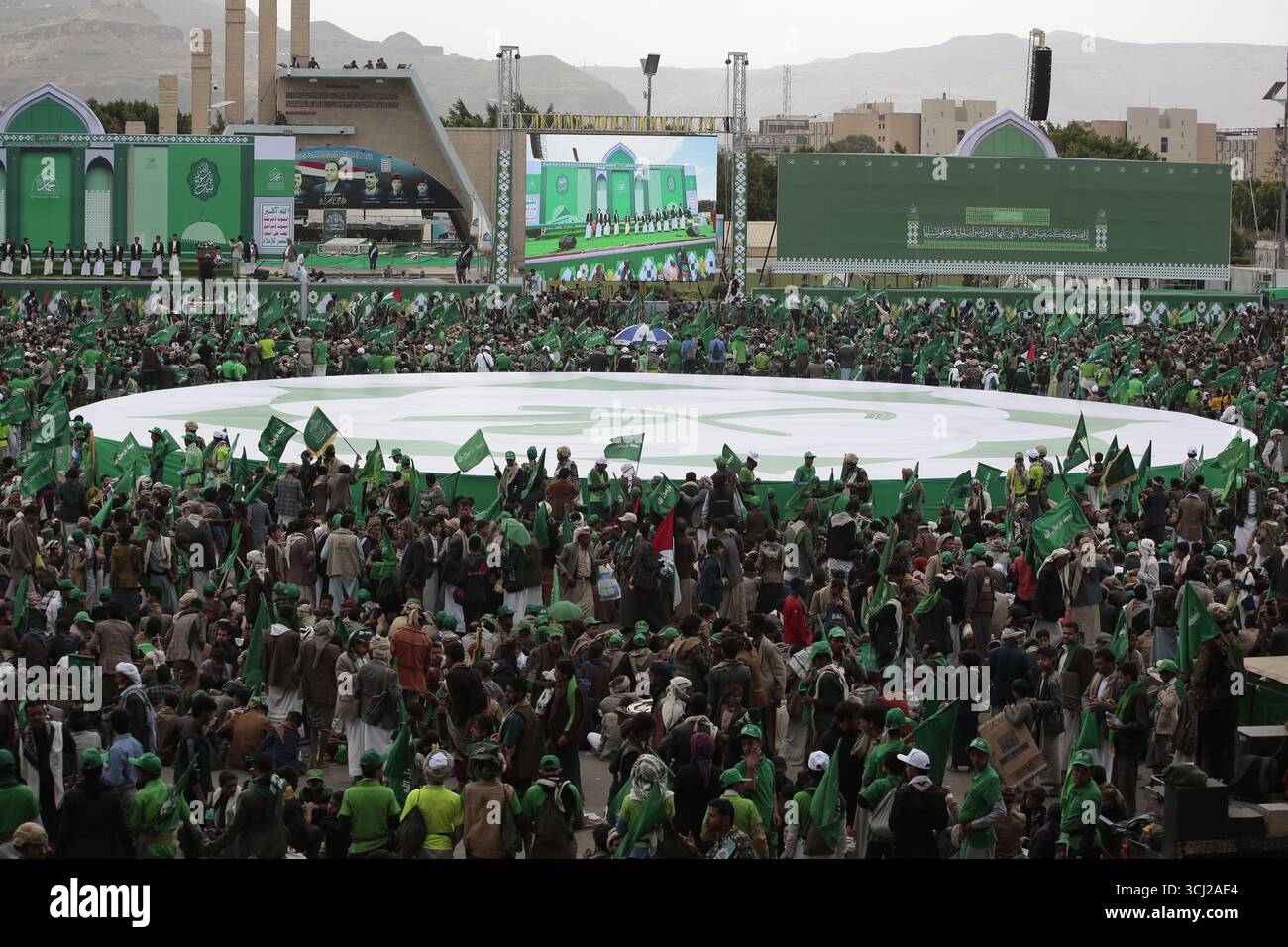People wave Islamic flags during the Mawlid celebration marking the ...