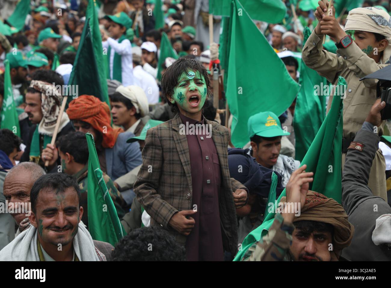 People wave Islamic flags during the Mawlid celebration marking the ...