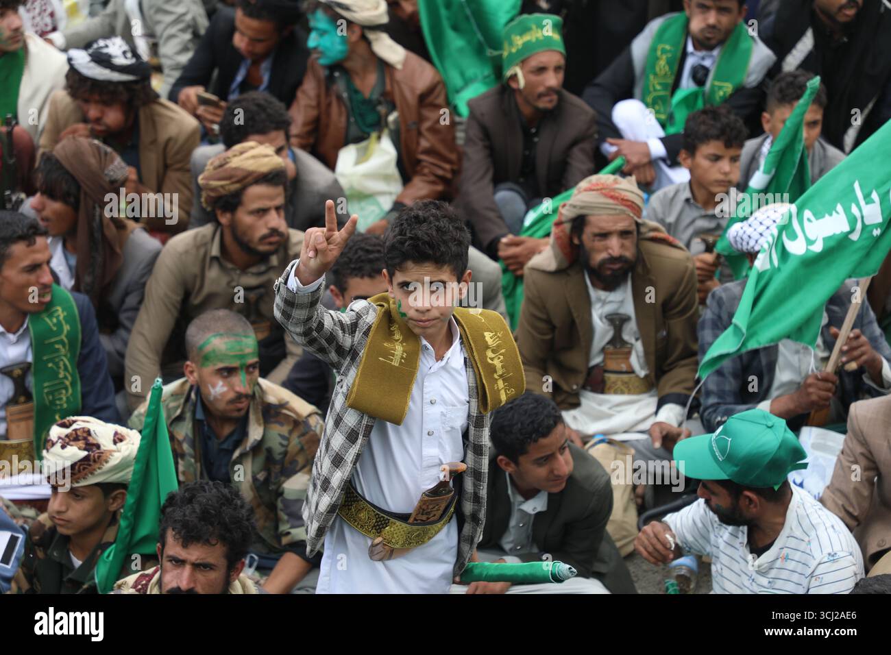 People wave Islamic flags during the Mawlid celebration marking the ...
