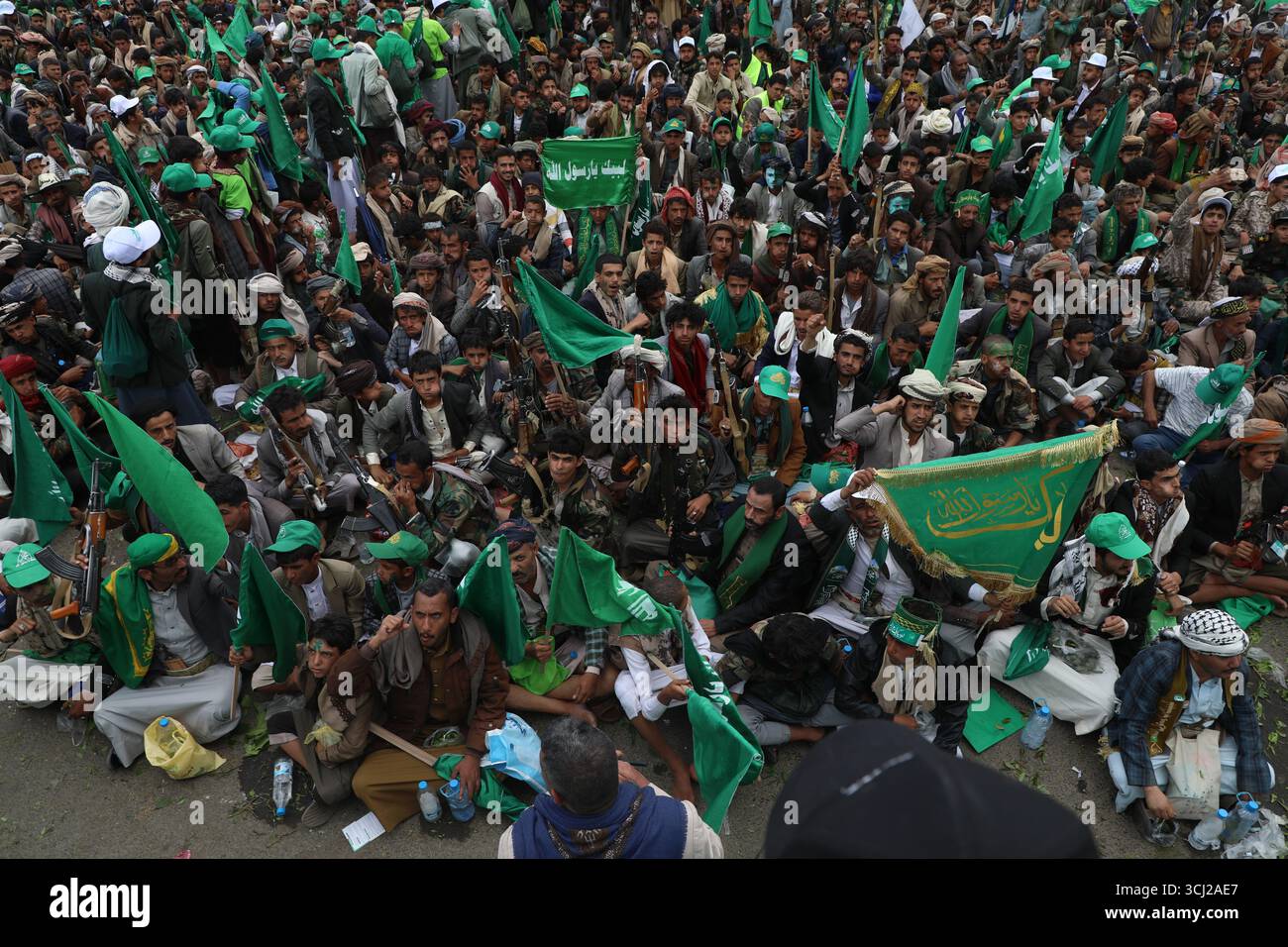 People wave Islamic flags during the Mawlid celebration marking the ...