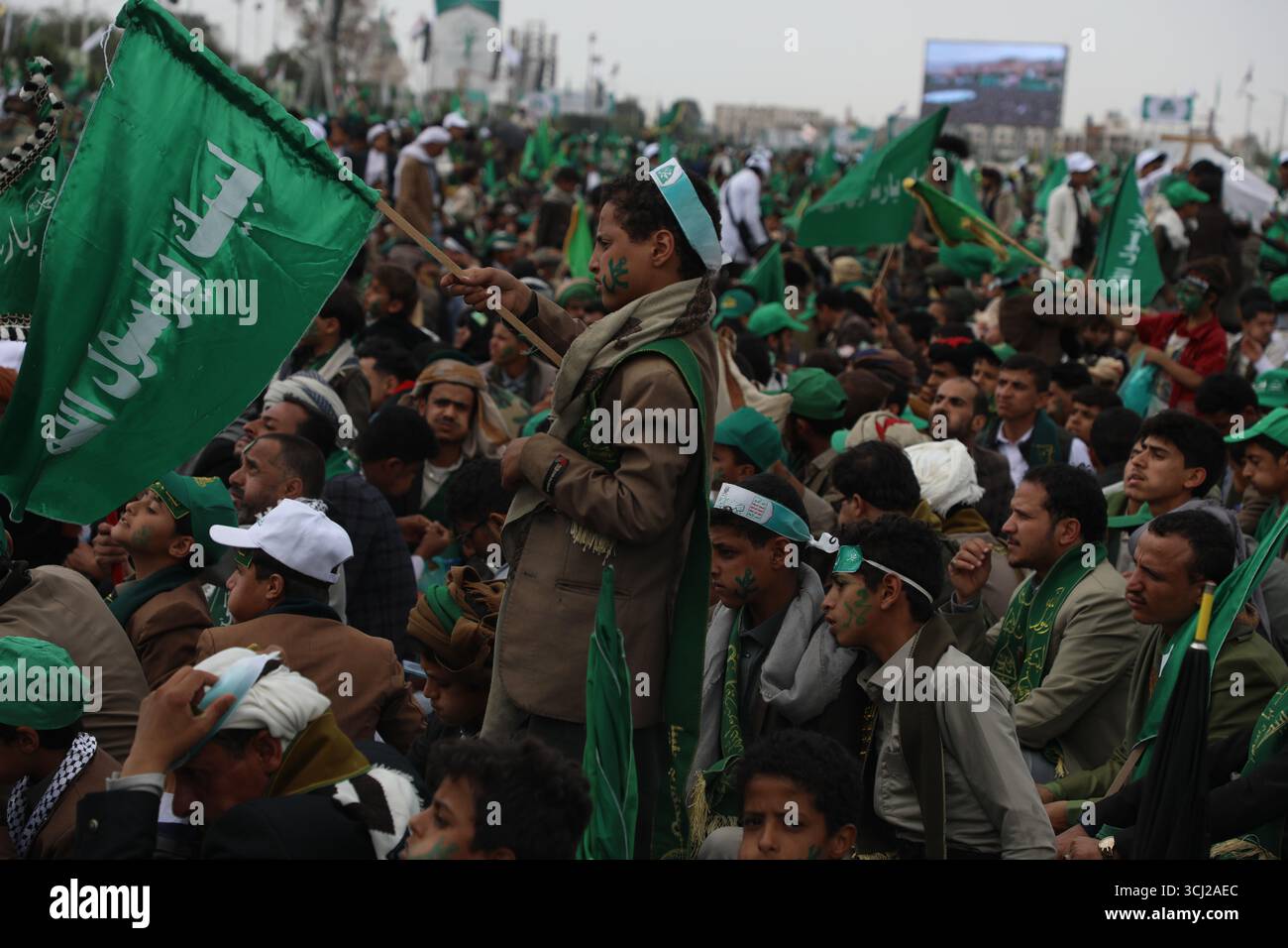 People wave Islamic flags during the Mawlid celebration marking the ...