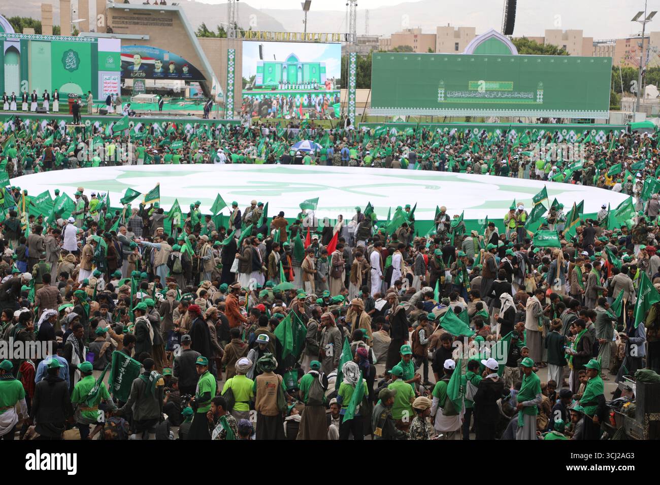 People wave Islamic flags during the Mawlid celebration marking the ...
