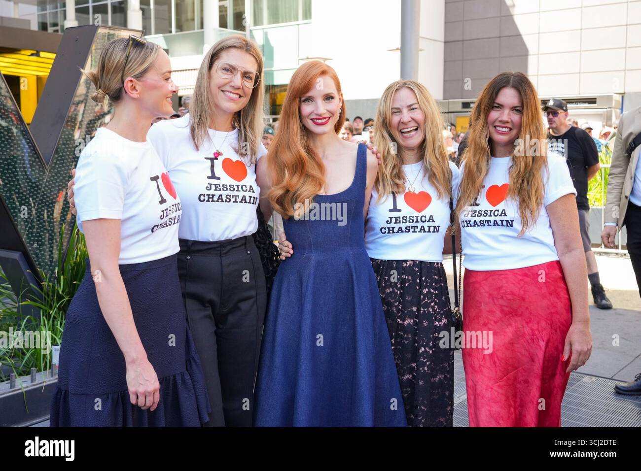 Jessica Chastain, center, poses with people wearing shirts with "I ...