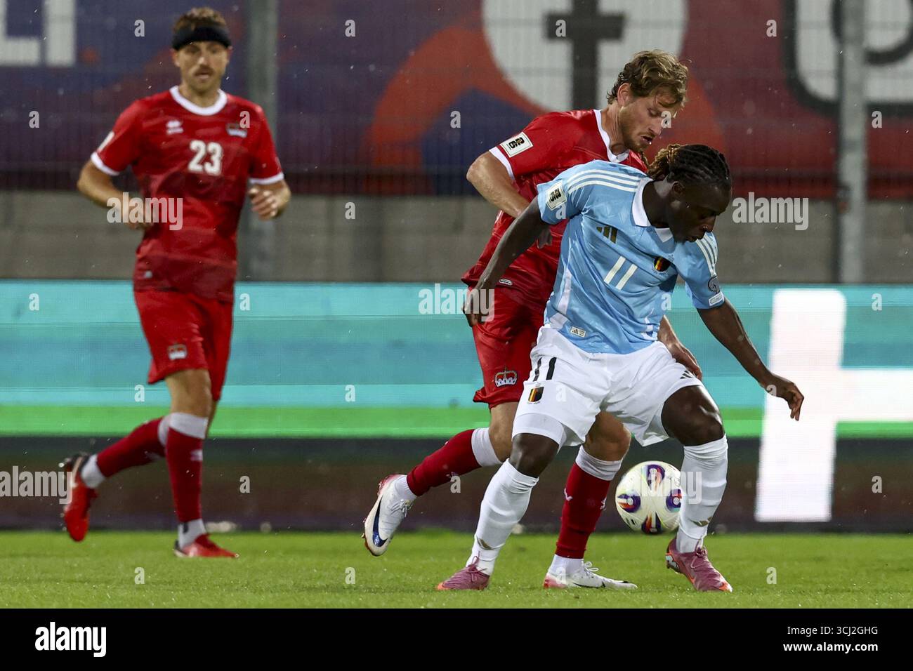 Liechtenstein's Jens Hofer and Belgium's Jeremy Doku pictured during a ...