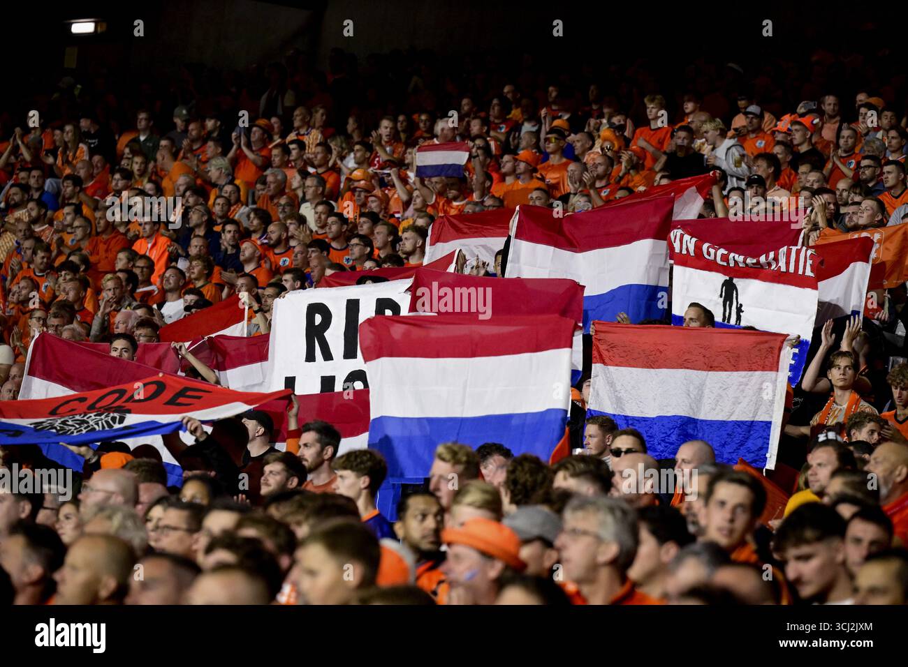 ROTTERDAM - Dutch supporters hold up Dutch flags in the 17th minute in ...