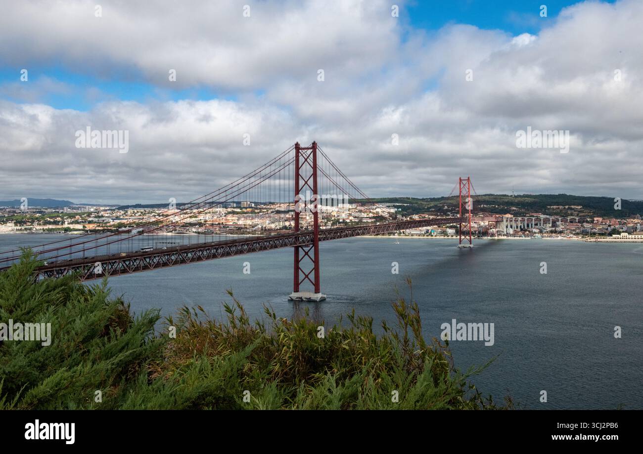 A wide-angle shot of the 25 de Abril Bridge in Lisbon, featuring its ...