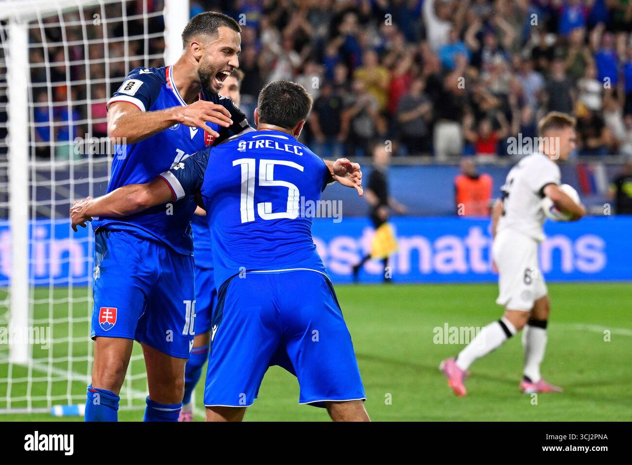 Slovakia's David Hancko, left. celebrates after scoring the opening ...