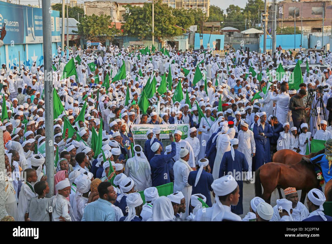 Residents raise green flags as they gather to celebrate Mawlid al-Nabi ...