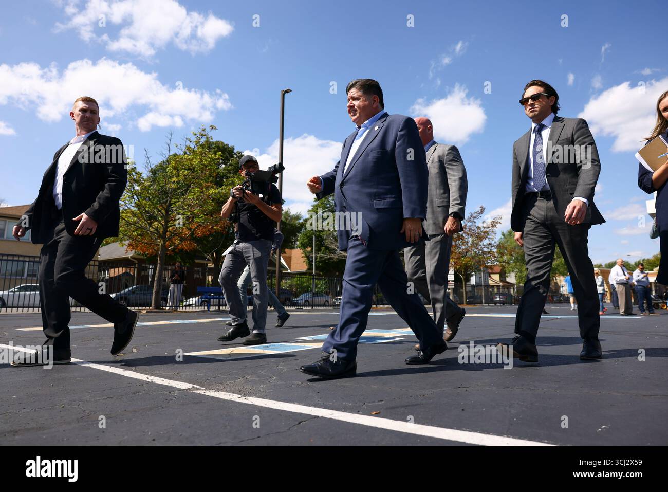 Gov. JB Pritzker walks back to his vehicle after speaking with ...