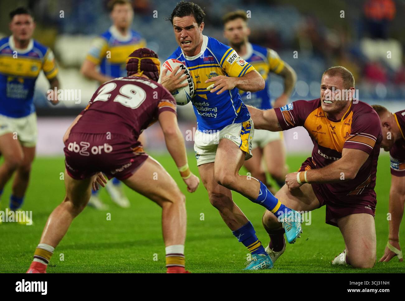 Leeds' Brodie Croft gets away from Huddersfield's Tom Burgess during ...
