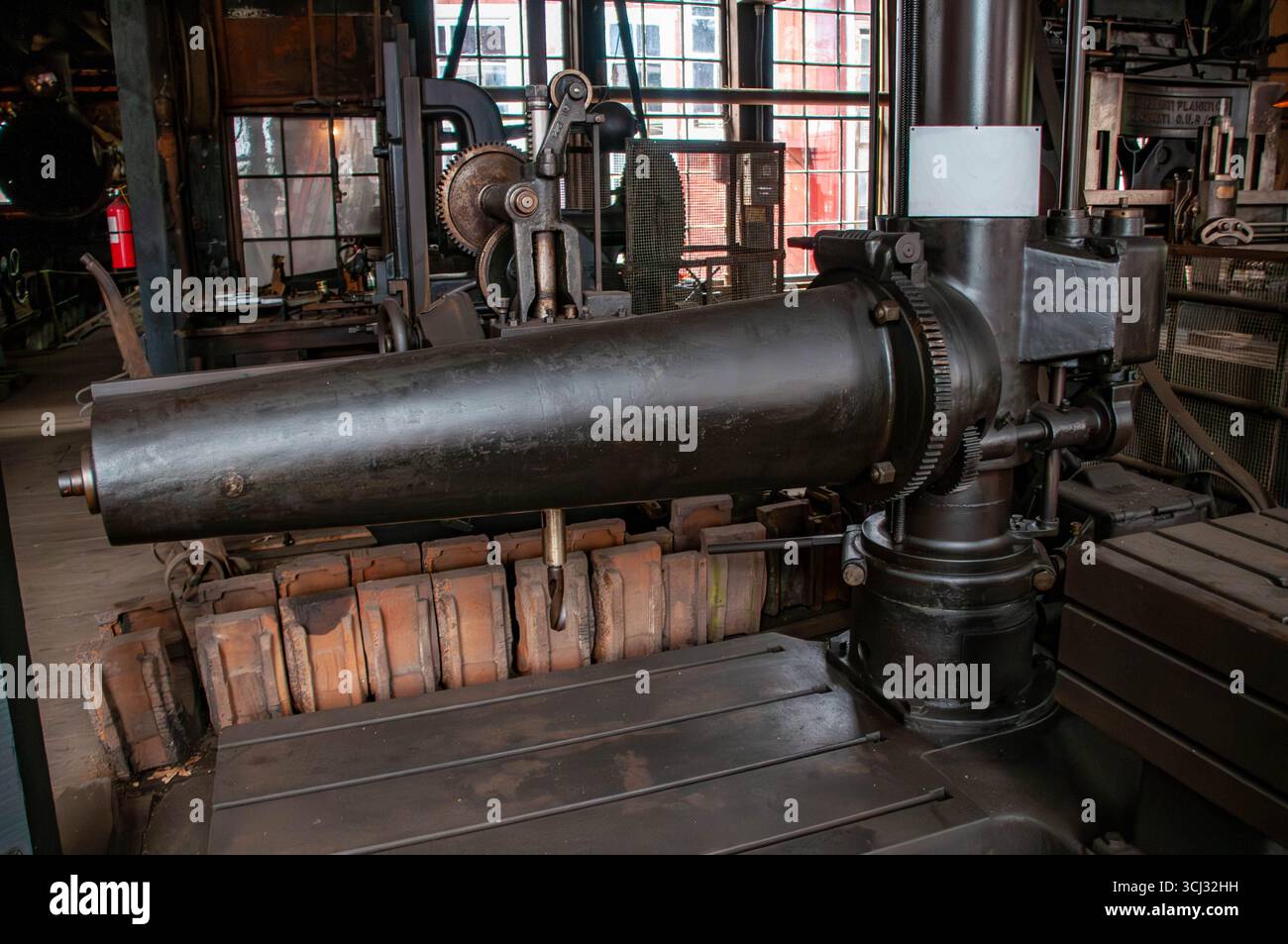 A close-up view showcases a vintage steam drill press part located in ...