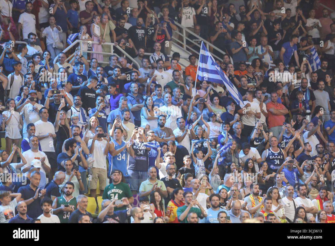 Greece fans celebrate their team's win. Spain plays against Greece for ...