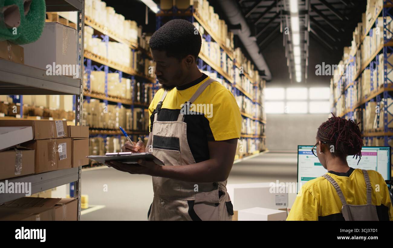 Woman employee placing adhesive shipping labels on boxes in depot ...