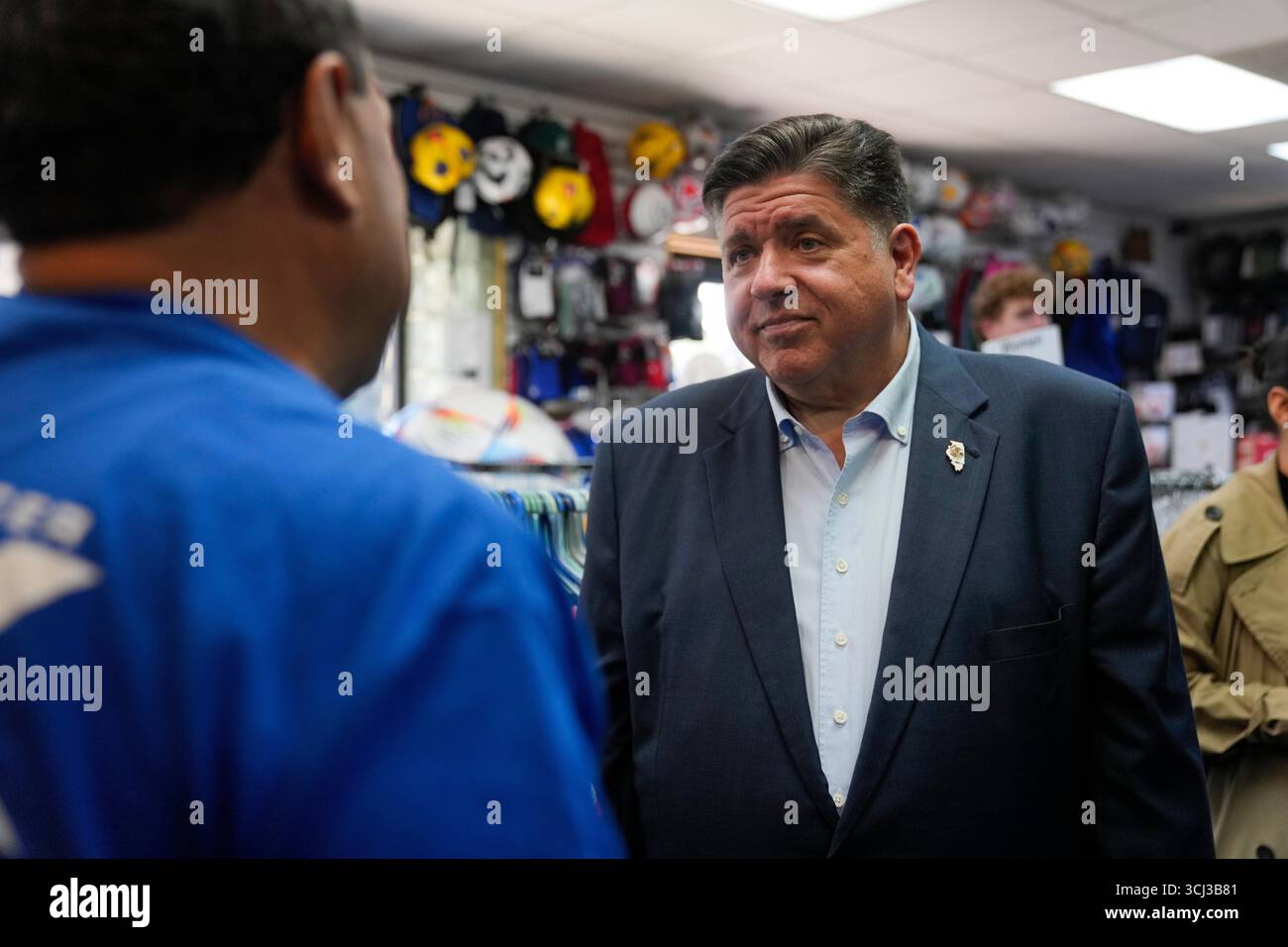 Illinois Gov. J.B. Pritzker, right, speaks with Leonel Tovar at his ...